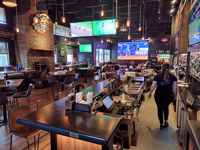 Inside, rustic charm meets modern comfort with stone walls, wooden accents, and strategically placed TVs&mdash;the perfect backdrop for serious barbecue contemplation.