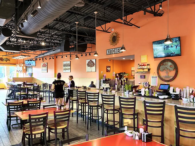 Warm orange walls and exposed ductwork create that perfect "industrial cozy" vibe. It's like breakfast decided to get an apartment in SoHo but kept its small-town charm.