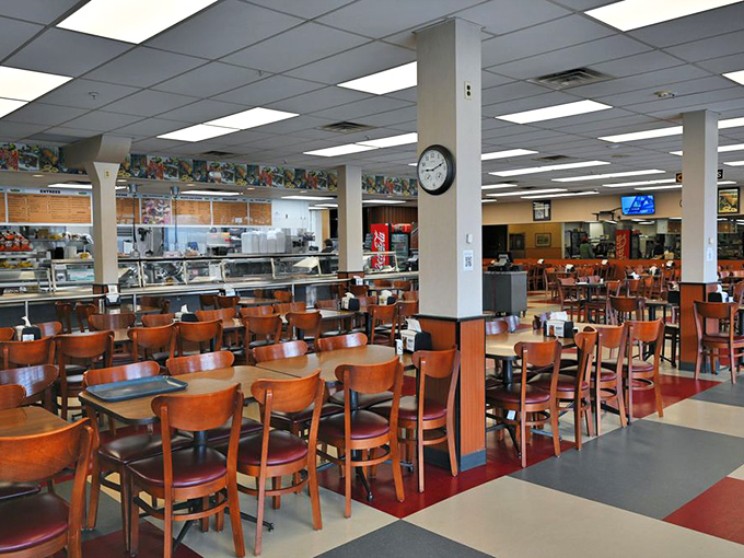 Cafeteria-style dining with no pretension&mdash;just wooden chairs, checkered floors, and the promise of sandwiches that require a strategic eating plan.