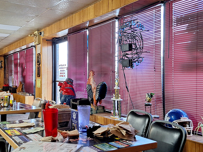 Wood paneling and red blinds create that classic "we care more about the food than the decor" vibe. That rooster statue isn't just for show&mdash;he's guarding barbecue excellence.