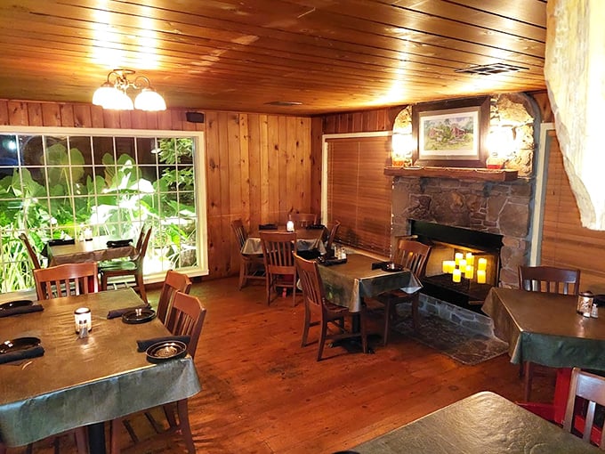 Knotty pine walls, a stone fireplace, and forest-green tablecloths create that perfect "I've discovered something special" moment. Cozy dining that whispers "take your time."