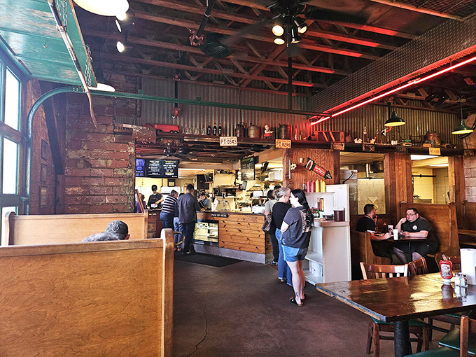 Inside Van's, the rustic wood beams and red neon create an atmosphere no corporate restaurant consultant could ever replicate. This is earned character.