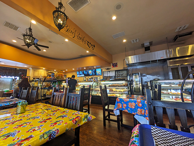 Colorful oilcloth-covered tables create a fiesta atmosphere inside, where pendant lights cast a warm glow over wooden chairs that have witnessed countless family gatherings.