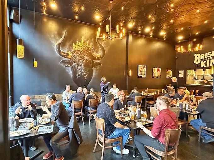Inside, the crowned bull mural watches over diners like a benevolent barbecue deity, silently approving as plates return empty and conversations flow between strangers united by smoke.