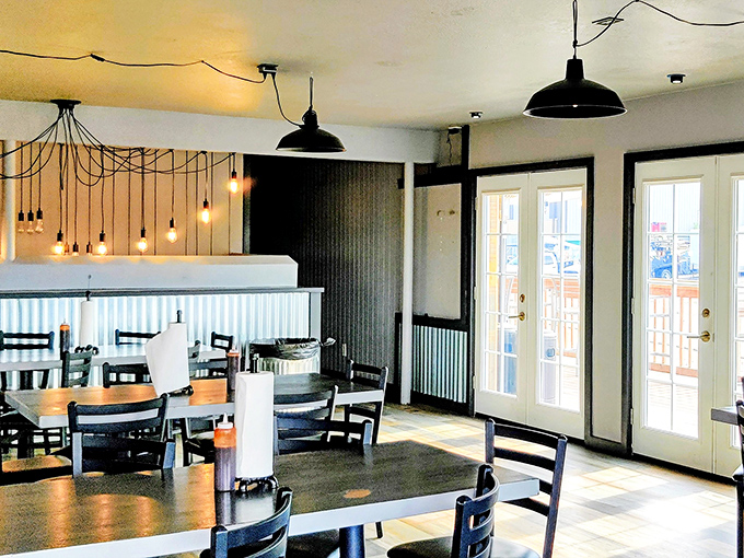 Industrial-chic meets barbecue comfort in this thoughtfully designed interior. Edison bulbs and corrugated metal create the perfect backdrop for the meat sweats you're about to earn.