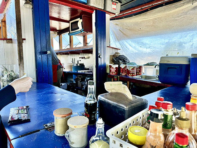 Inside this nautical kitchen, magic happens in close quarters. The compact blue counter space is where seafood dreams come true.