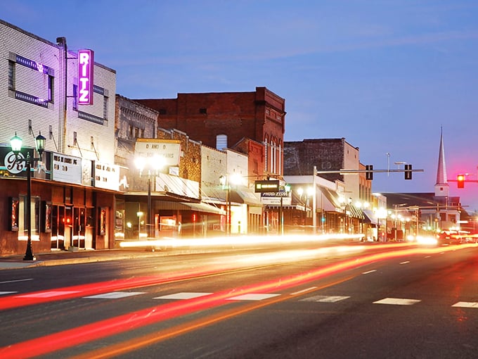As night falls on Malvern, the historic Ritz Theater's neon sign transforms Main Street into a nostalgic postcard from a time when movies were events, not just streams.