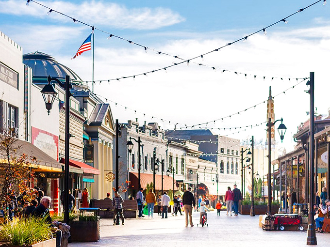 String lights crisscross above Mill Street like a canopy of stars, inviting visitors to stroll, shop, and savor the small-town magic.