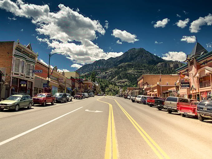 Main Street stretches toward infinity, where Victorian architecture meets mountain majesty. The ultimate small-town backdrop that Hollywood couldn't improve upon.