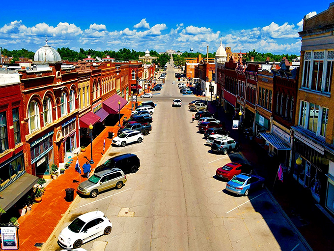 Downtown Guthrie stretches toward the horizon under Oklahoma's impossibly blue sky, a red-brick canvas telling stories of frontier ambition and architectural flair.
