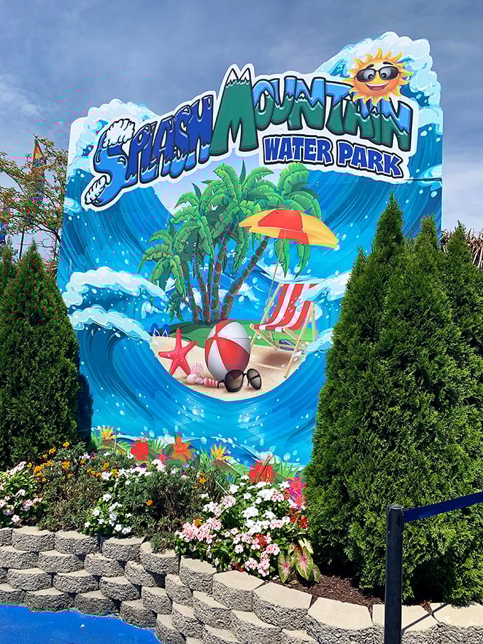 The cheerful Splash Mountain sign stands like a portal to childhood summers, complete with a sunglasses-wearing sun who clearly knows how to party.