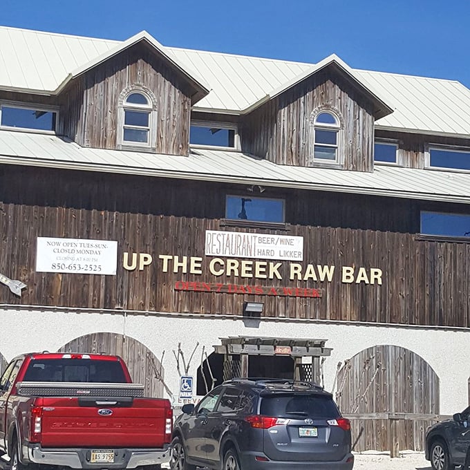 Up The Creek Raw Bar's weathered wooden exterior isn't just authentic Florida—it's a siren song for seafood lovers seeking the real deal.