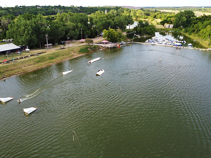 Oklahoma's answer to aquatic adventure from above. The serene lake setting hides the chorus of gleeful screams and spectacular splashes happening below.