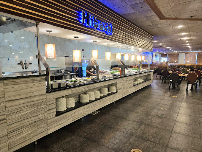 The "Hibachi" station gleams with promise, where chefs transform simple ingredients into sizzling masterpieces while hungry patrons strategize their buffet approach.