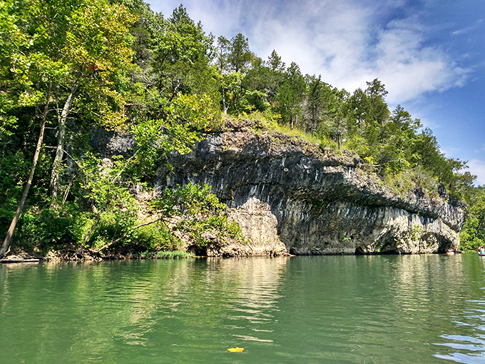 Nature's architecture at its finest&mdash;limestone bluffs rising dramatically from emerald waters, creating a postcard-worthy scene that no filter could improve.