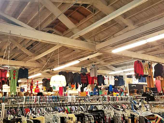 Endless racks stretch toward exposed wooden beams, creating a treasure hunter's paradise where fashion from every era finds new life. 