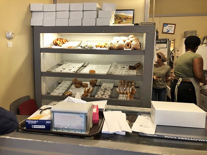 The counter where dreams come true, one donut at a time. No fancy digital menus here&mdash;just handwritten signs and display cases that have witnessed thousands of morning smiles.