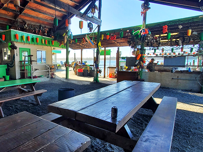 Rustic picnic tables under colorful buoys create the perfect "no-frills dining room" where memories are made between bites of briny perfection.