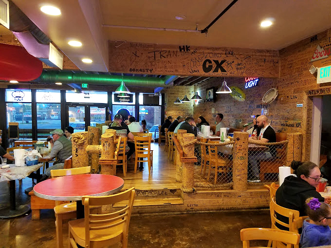 Signatures cover the walls like a culinary guestbook. Each scribble tells the story of someone who came hungry and left converted to the crawfish cause.