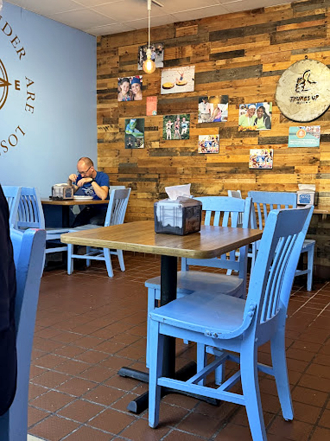 Rustic wooden walls adorned with customer photos tell stories of seafood pilgrimages past, while those blue chairs invite you to create your own delicious memory.