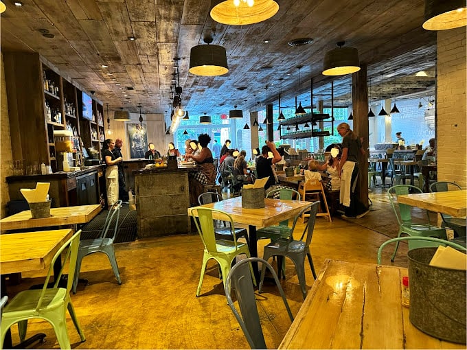 Inside, industrial-chic meets seaside nostalgia with concrete ceilings and colorful metal chairs &ndash; proof that great seafood doesn't require ocean views, just serious culinary commitment.