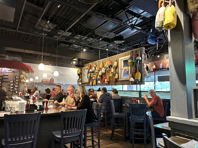Colorful buoys dangle from the ceiling like maritime Christmas ornaments, creating the perfect backdrop for seafood feasts and animated dinner conversations.