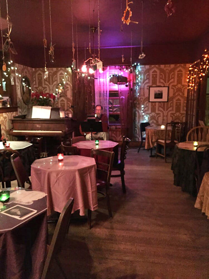 Mismatched tables, vintage wallpaper, and string lights create the perfect backdrop for late-night conversations and unexpected surprises.