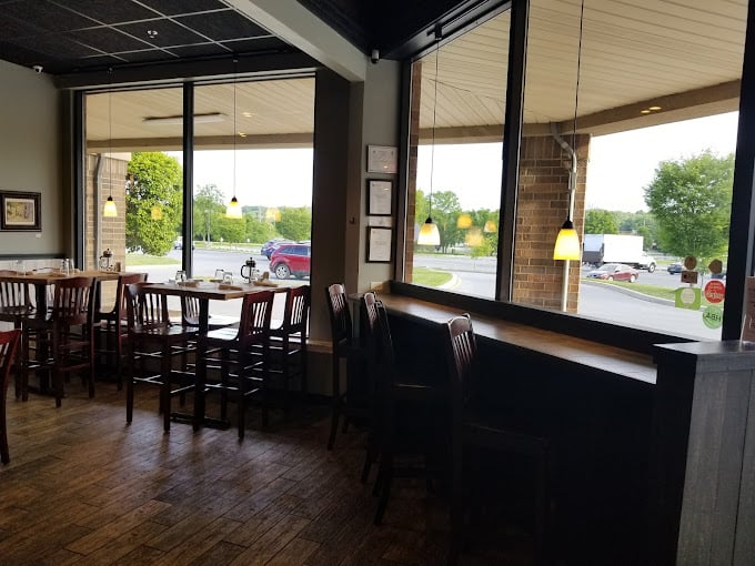 Natural light floods the simple, welcoming interior. The kind of place where coffee tastes better and morning conversations flow as smoothly as their maple syrup.