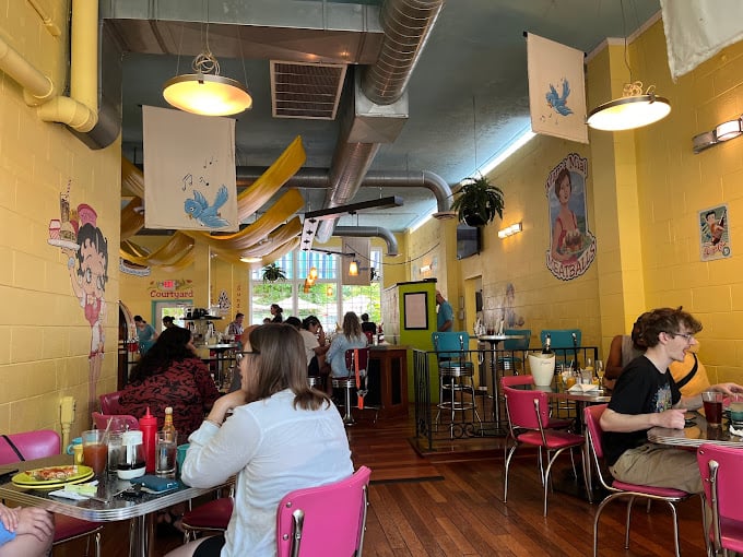 Step inside and you've entered breakfast nirvana, where yellow walls and colorful chairs create the perfect backdrop for morning magic.