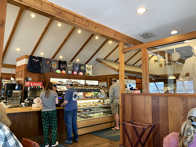 Wooden beams, warm lighting, and the promise of sugar-laden bliss. This isn't just a bakery counter&mdash;it's the pearly gates of pastry heaven.