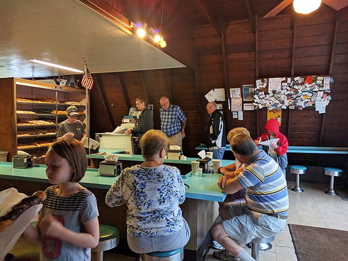 Morning pilgrims gather at the counter, participating in a ritual that's been bringing Lafayette locals together for generations.