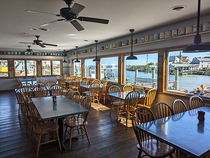 Inside JP's, Windsor chairs and water views create the perfect maritime living room. Those coffee mugs lining the shelves? Each one tells a story.