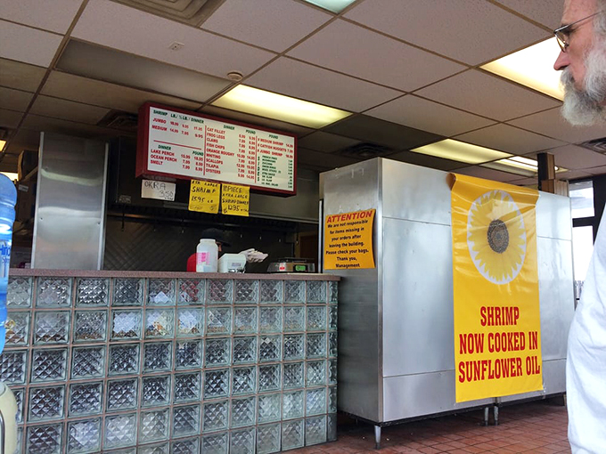 Behind that glass-block counter, culinary magic happens daily. The "Sunflower Oil" banner announces their commitment to quality cooking methods.