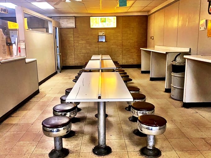 Diner-style seating with fixed stools tells you everything you need to know&mdash;this place prioritizes donuts over interior design, exactly as it should.