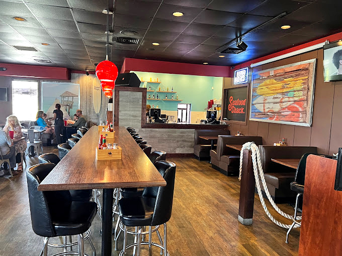 Inside, nautical touches and comfortable seating create that perfect "I've discovered something special" atmosphere. The rope details aren't just decorative&mdash;they're foreshadowing the seafood treasures to come.