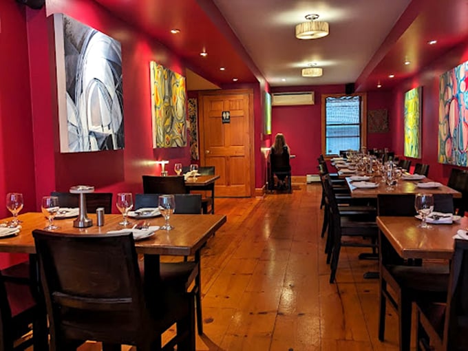 Moya's vibrant red dining room isn't just a feast for the eyes—it's the prelude to the culinary symphony that awaits, with local artwork providing the perfect visual accompaniment.