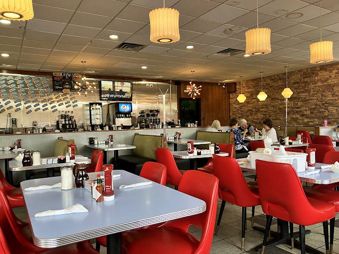 Red chairs that pop like exclamation points against the warm stone wall. This isn't just a diner&mdash;it's Delaware's living room.