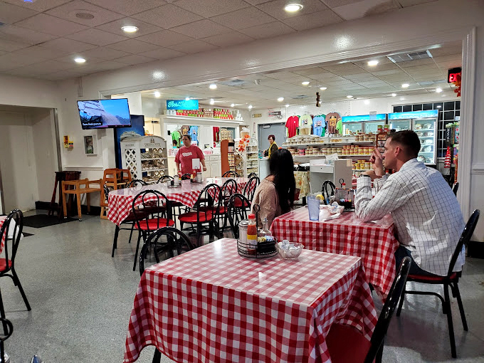 Classic red-checkered tablecloths set the stage for culinary memories. This isn't interior design&mdash;it's a promise that authentic, unfussy goodness awaits.