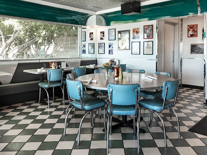 Those turquoise chairs aren't just seating&mdash;they're time machines. The checkerboard floor and chrome accents transport you to an era when conversations happened face-to-face, not screen-to-screen.