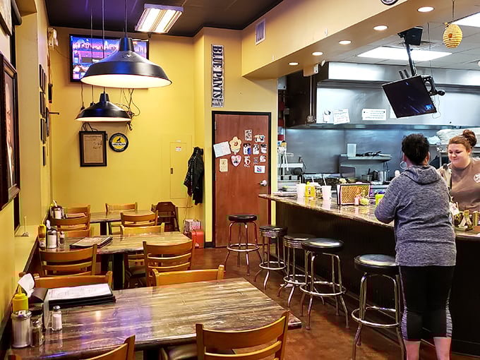 Yellow walls radiate morning optimism as counter seating offers front-row tickets to the breakfast symphony. This is where memories are made, one biscuit at a time.