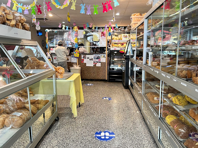 Colorful papel picado banners dance overhead as display cases beckon with promises of carb-laden bliss. This is where bread dreams come true.
