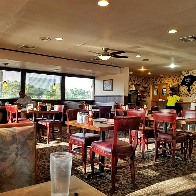 Red vinyl chairs and warm lighting create the perfect backdrop for memorable meals. This isn't interior design&mdash;it's comfort engineering at its finest.