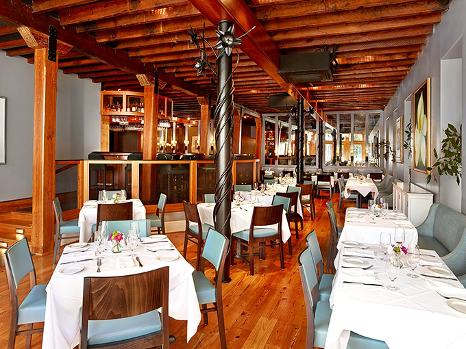 Inside Magnolias, twisted columns and exposed wooden beams create a space where history and haute cuisine dance together on pine floors polished by decades of happy diners.
