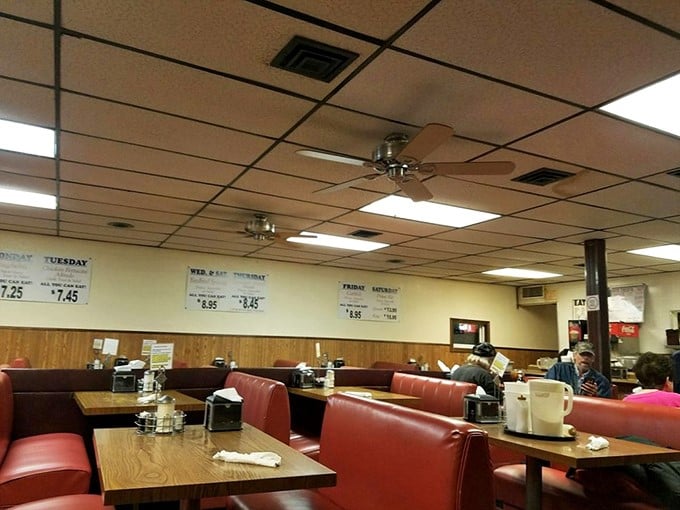 Red vinyl booths and wood paneling create a time capsule of American dining where conversations flow as freely as the coffee refills.