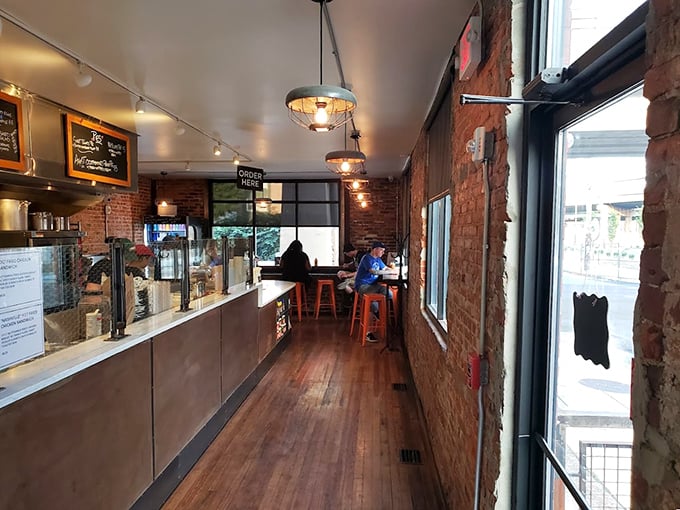 Exposed brick walls and wooden floors create the perfect stage for fried chicken drama to unfold.