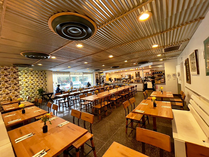 Industrial chic meets homey comfort inside Poppy + Rose, where the corrugated metal ceiling and wooden tables create the perfect backdrop for breakfast magic.