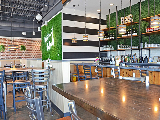 Industrial meets homey in this clever design. The signature green wall, wood accents, and modern lighting create the perfect backdrop for breakfast euphoria.