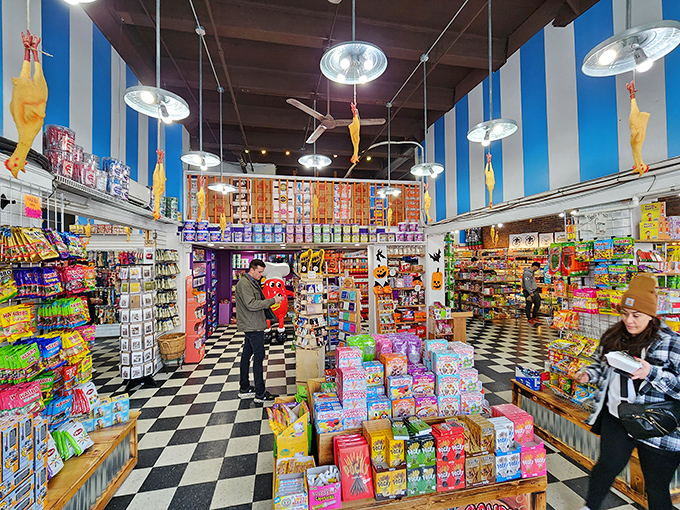 The black and white checkered floor says "classic," but the floor-to-ceiling candy says "wonderland." Notice the rubber chickens dangling from above? Pure genius.