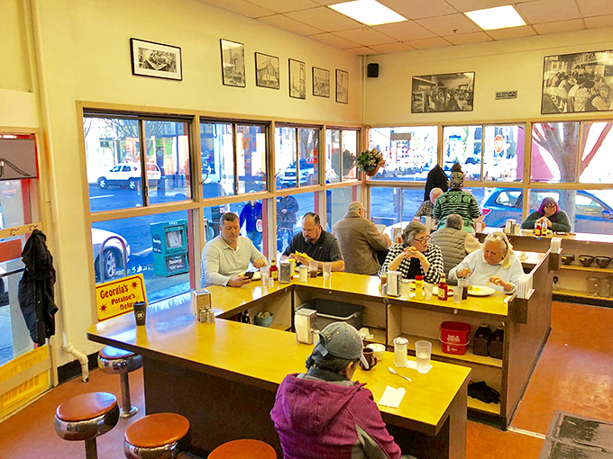The classic U-shaped counter with those signature red stools isn't just seating&mdash;it's front-row tickets to the breakfast theater.