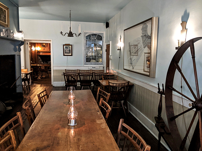 Step back in time in this colonial dining room where oil lamps cast a warm glow over wooden tables that have hosted generations of happy diners.